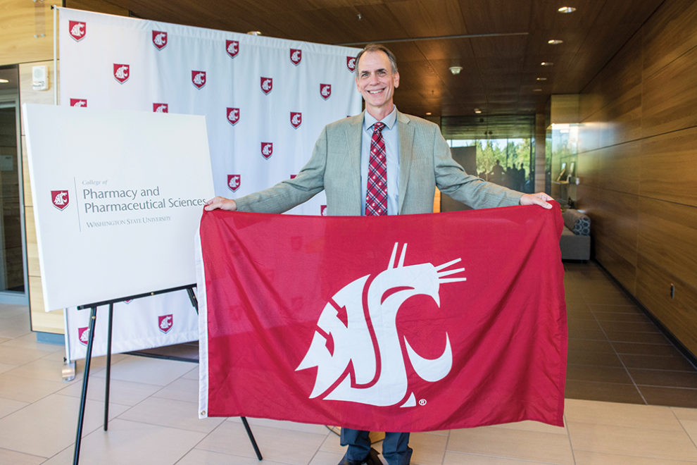 Gary-Pollack-with-Flag | Communications | Washington State University